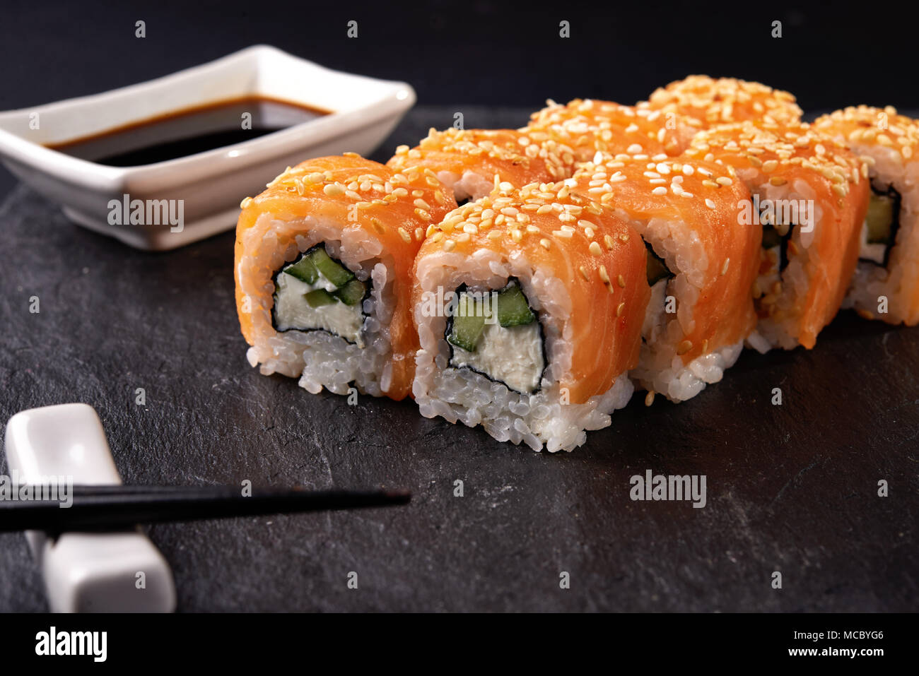 philadelphia maki sushi on black background Stock Photo - Alamy