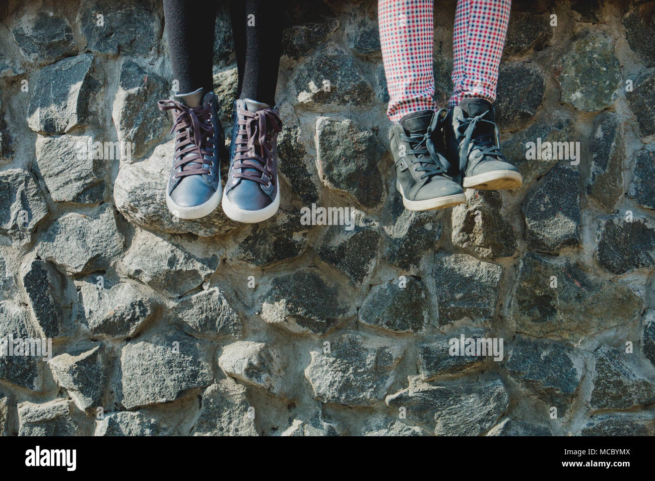 dangling baby girl's feet in shoes Stock Photo - Alamy