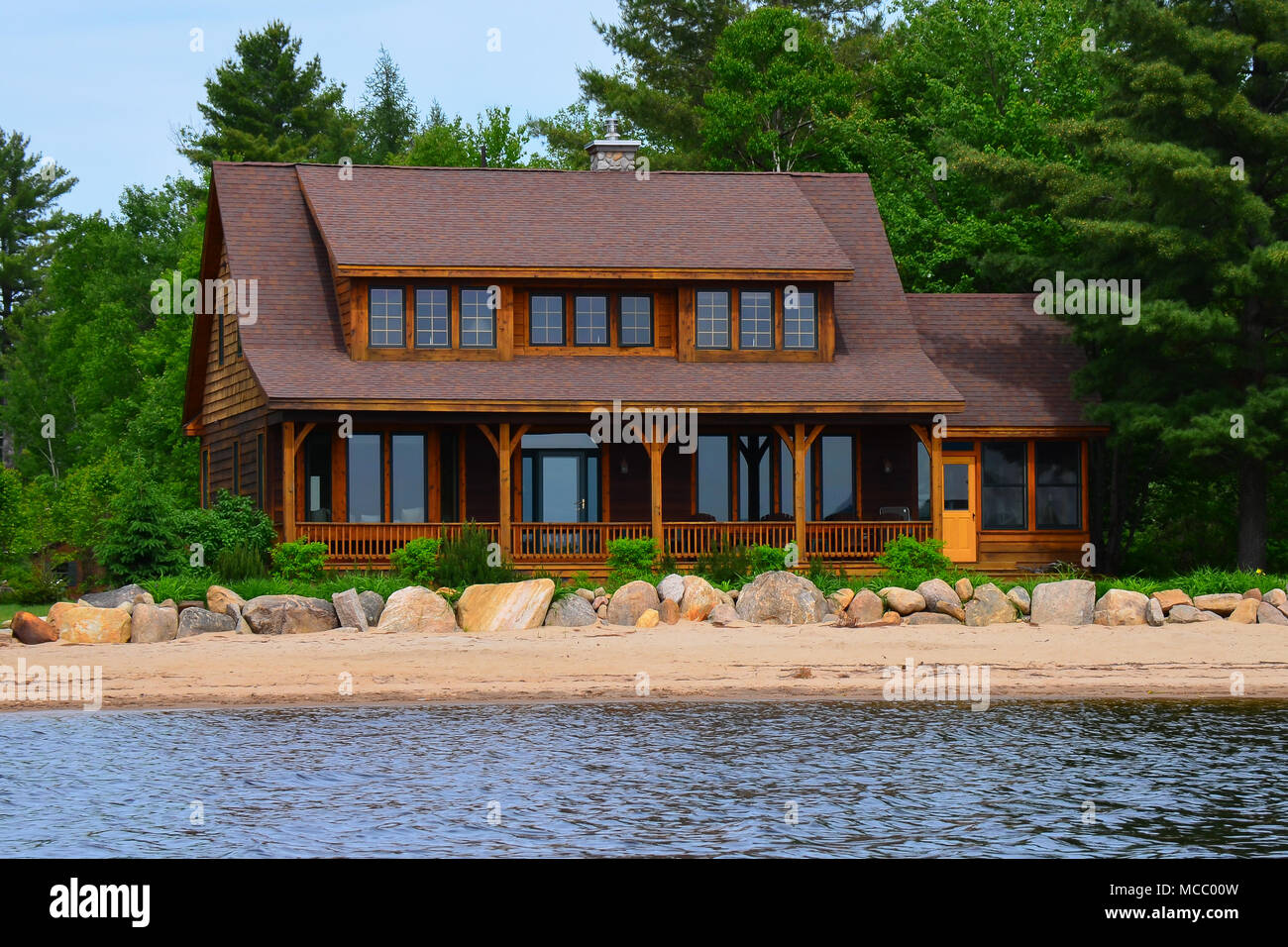 Fancy lake front home in the Adirondack Mountains, NY, surrounded by ...