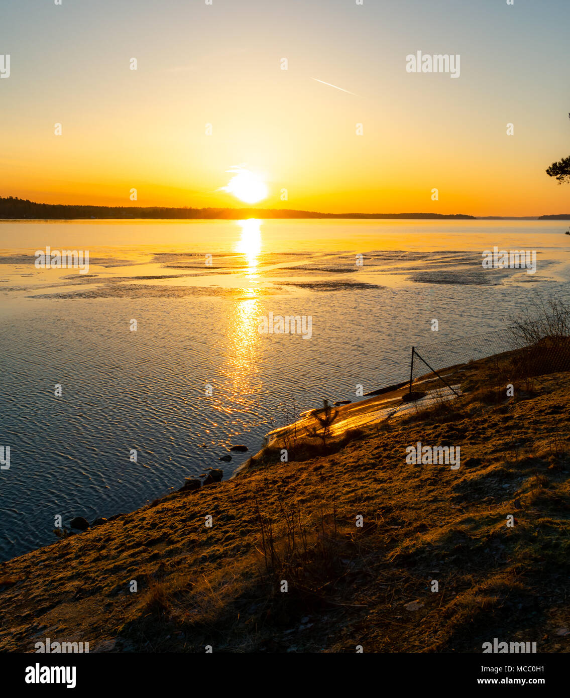 Sunrise over water Stock Photo - Alamy