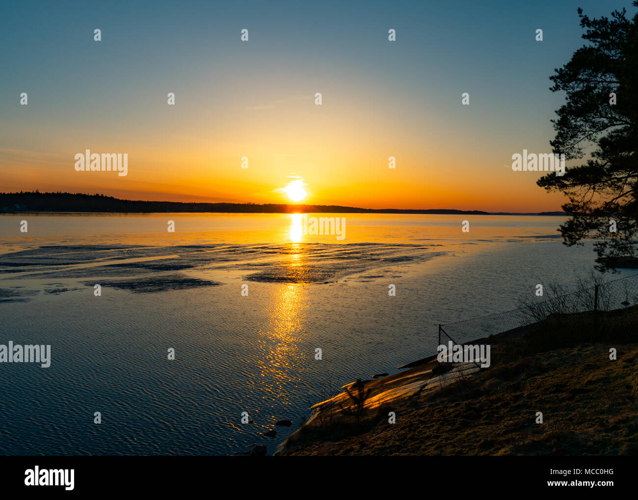 Sunrise over water Stock Photo - Alamy