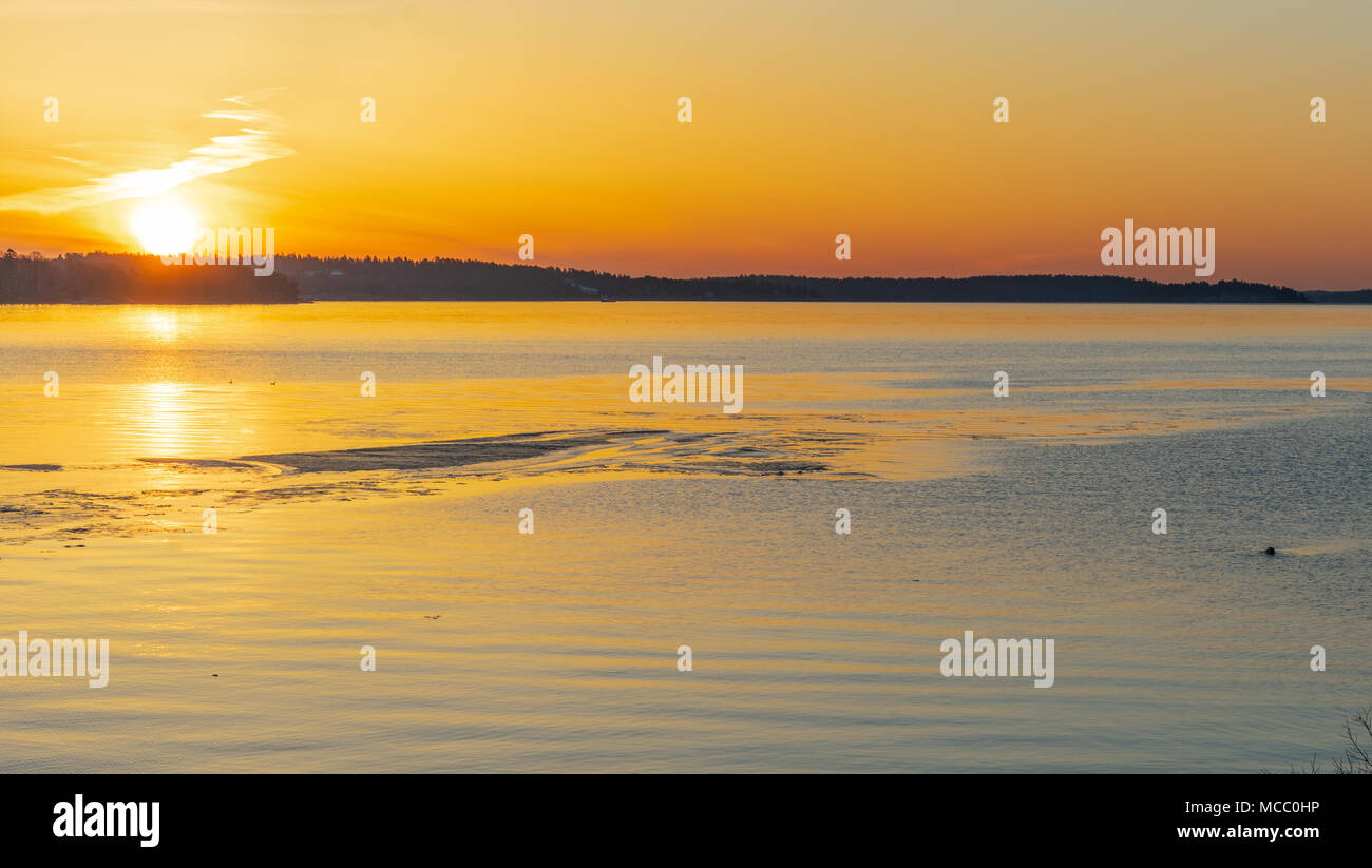 Sunrise over water Stock Photo - Alamy