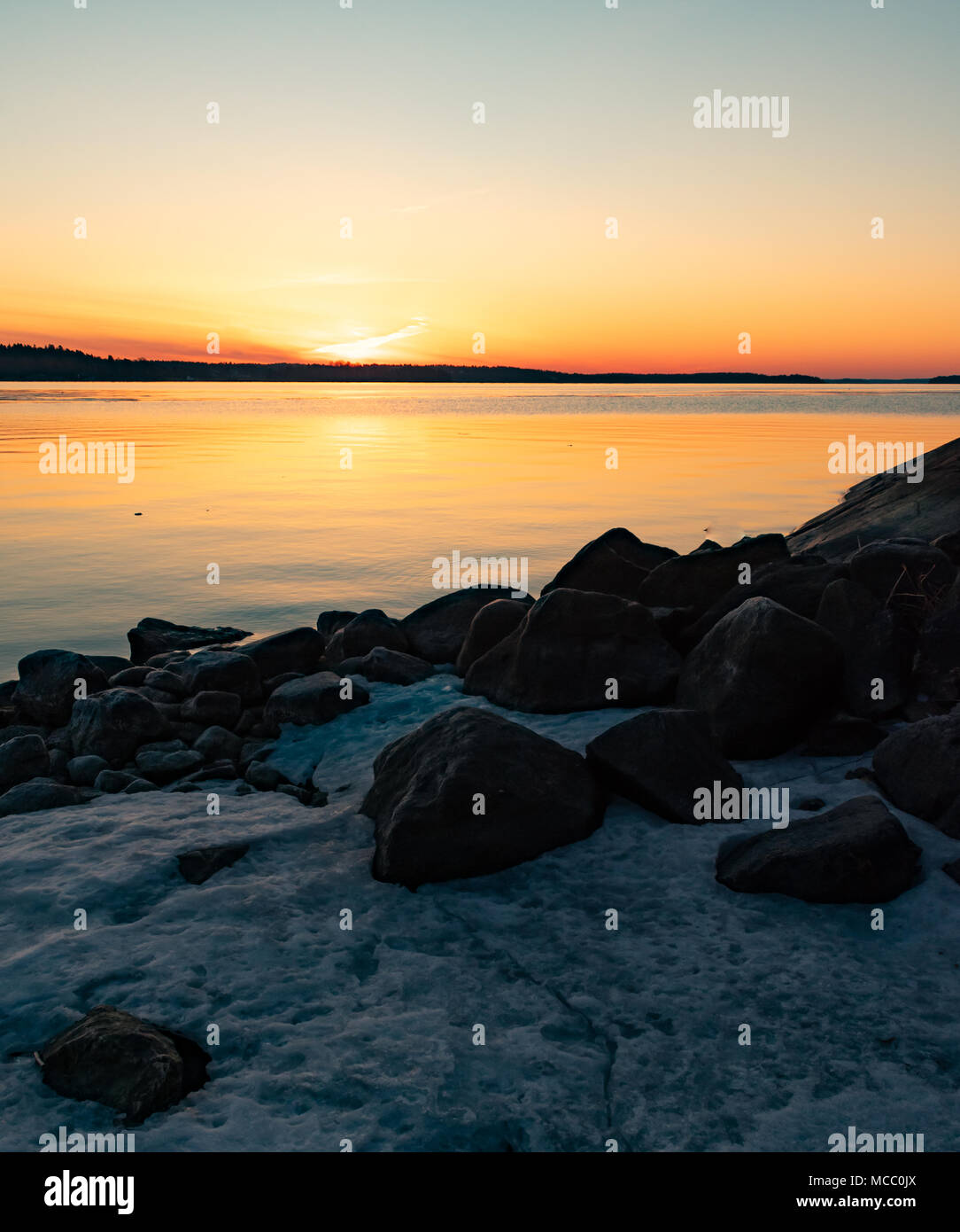 Sunrise over water Stock Photo - Alamy
