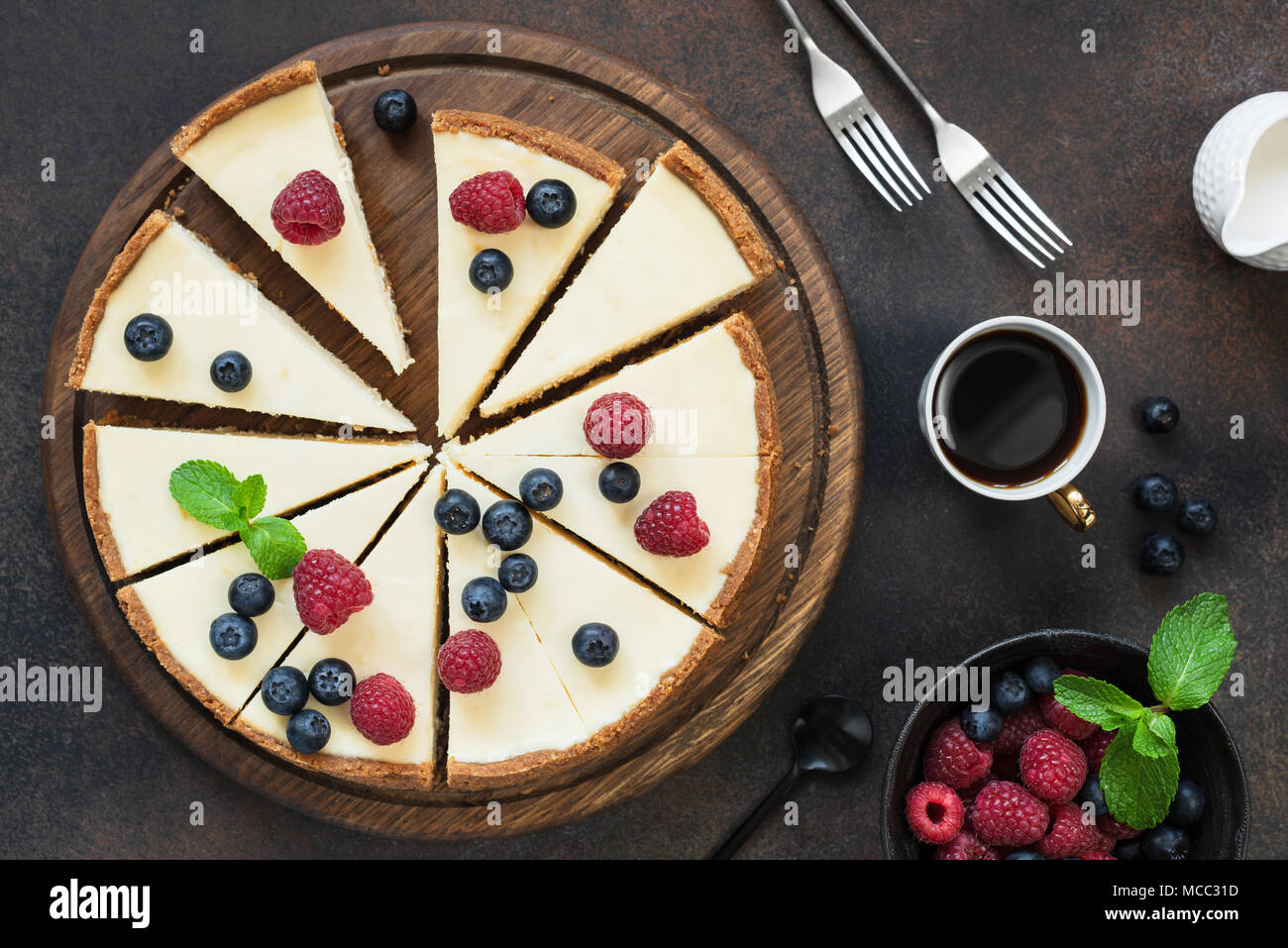 Top view of cheesecake with summer berries on dark background ...