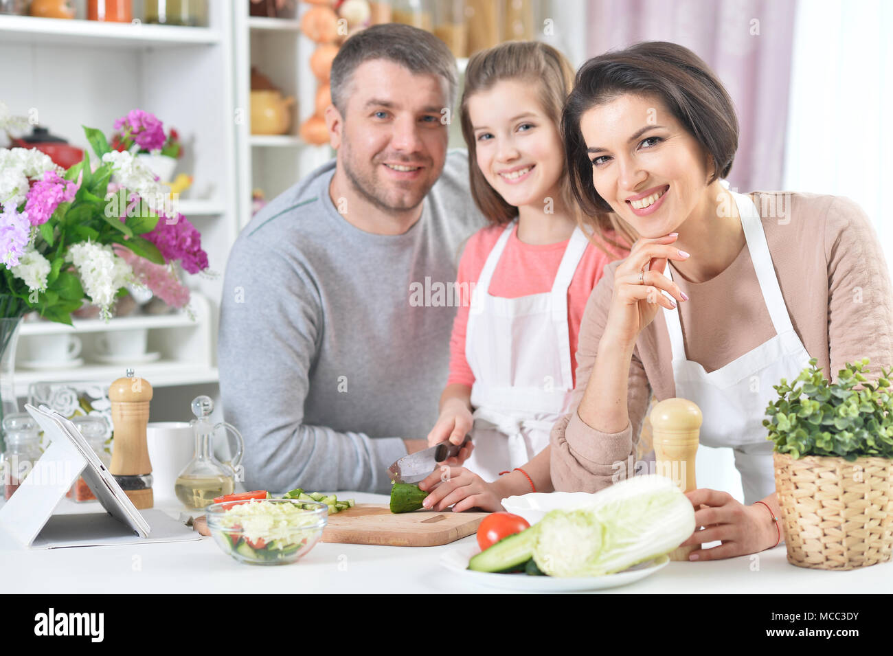 Young family cooking together Stock Photo - Alamy