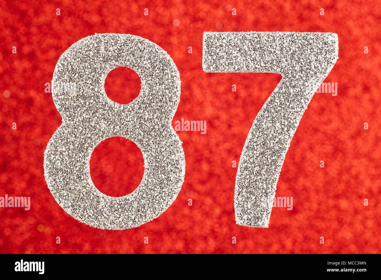 Number eighty-seven silver color over a red background. Anniversary ...