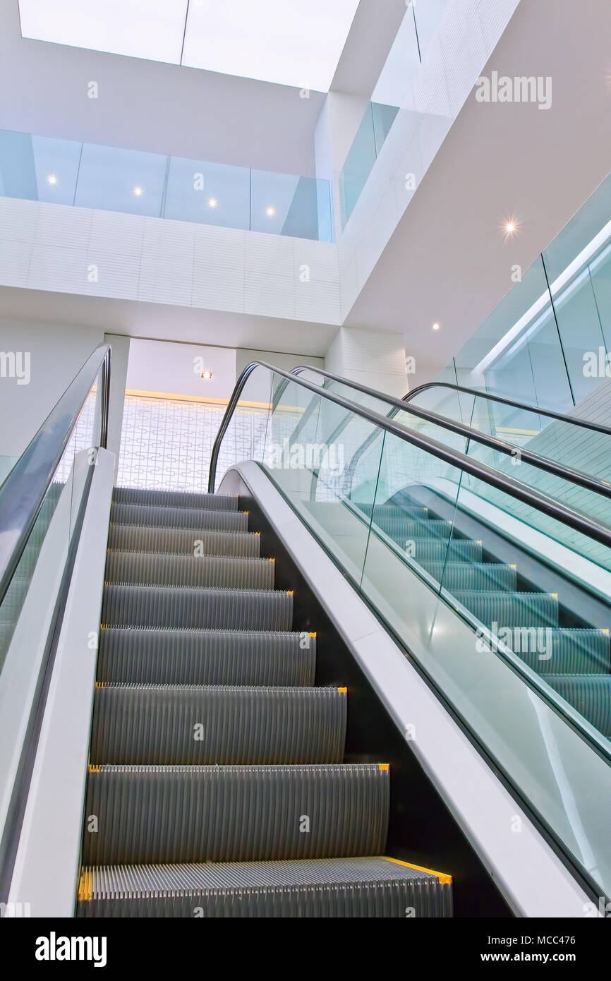 Modern design office interior with an escalator Stock Photo - Alamy