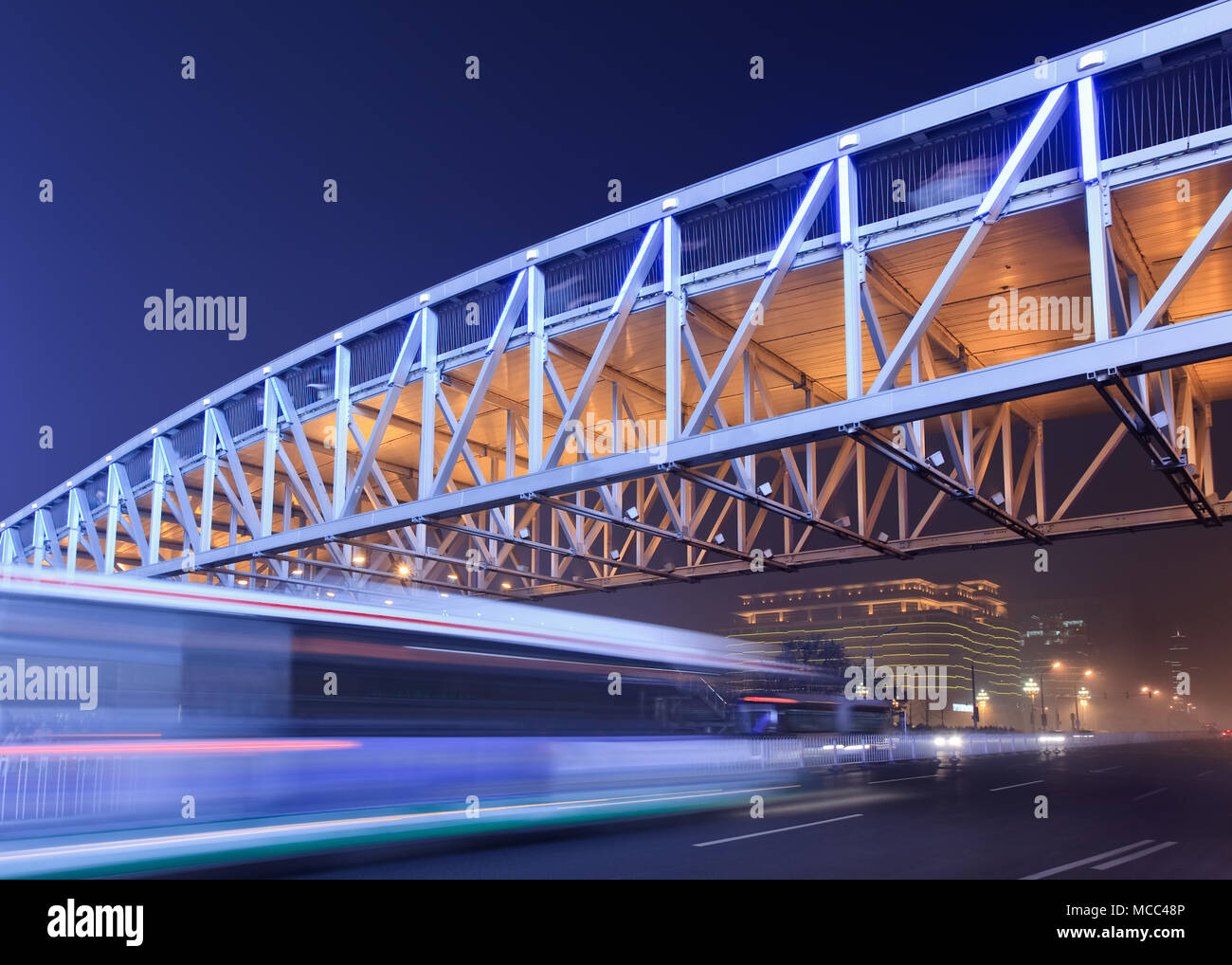 Pedestrian bridge with traffic in motion blur at night, Beijing center ...