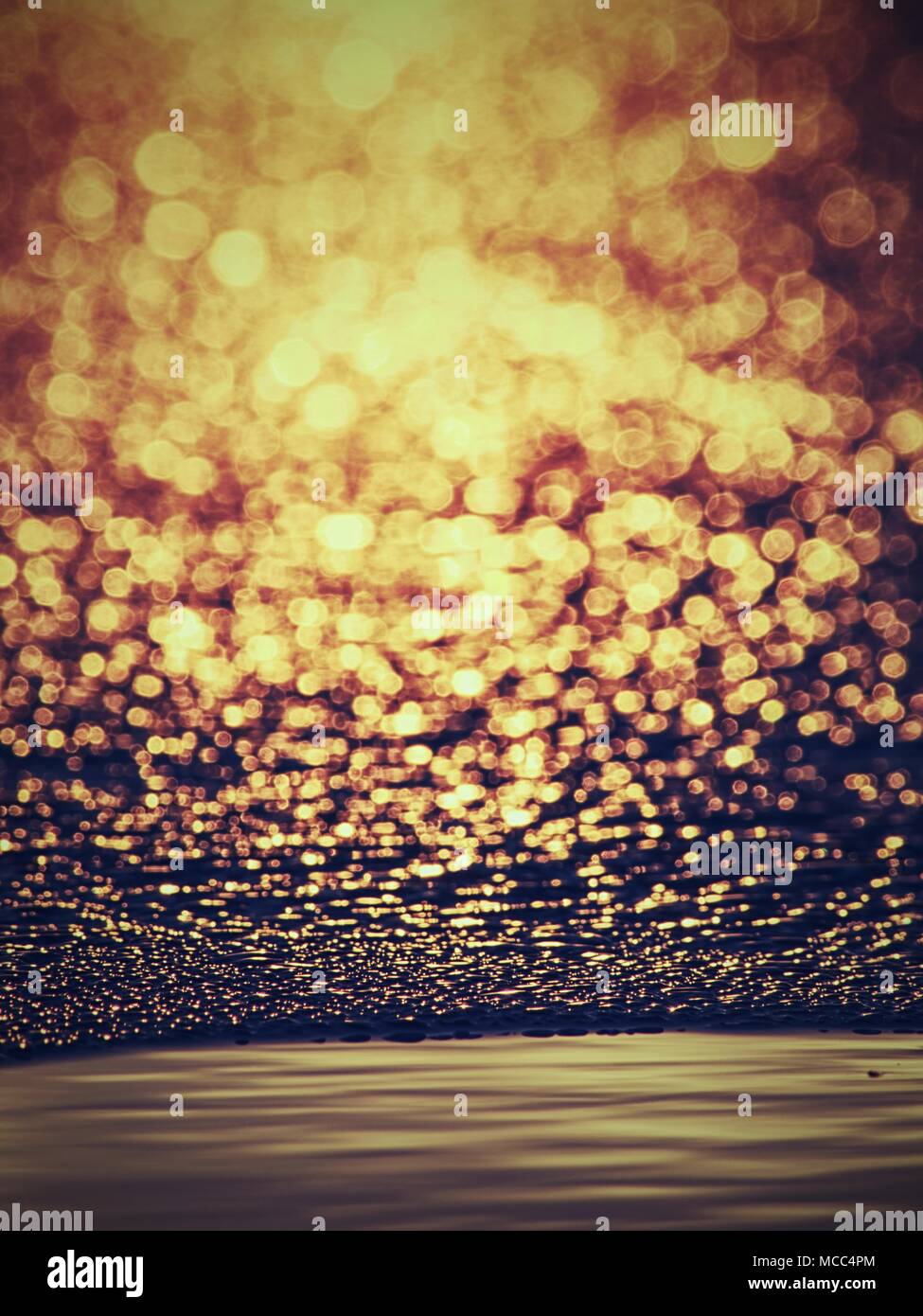 Ice edge. Edge of orange yellow water thawed from under a brilliant ...