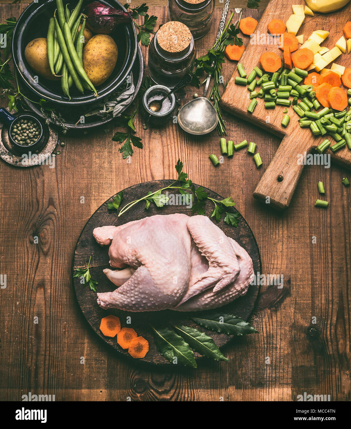 Raw whole chicken on rustic wooden kitchen table background with ...