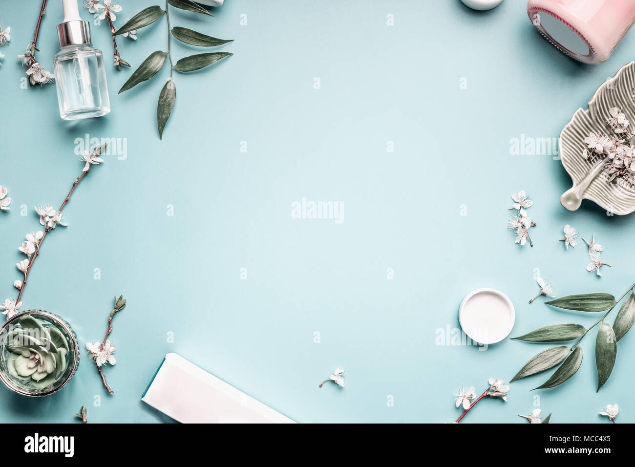 Beauty background with facial cosmetic products, leaves and cherry ...