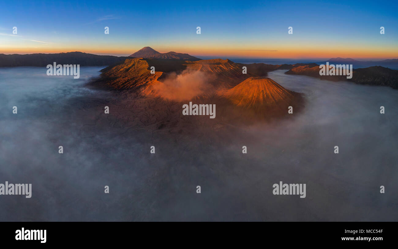 Aerial Panoramic view of Mount Bromo covered with mist at sunrise ...