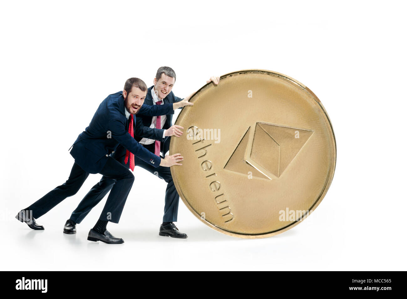 Two business men holding business icon Stock Photo - Alamy