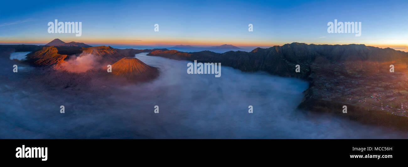 Aerial Panoramic view of Mount Bromo covered with mist at sunrise ...