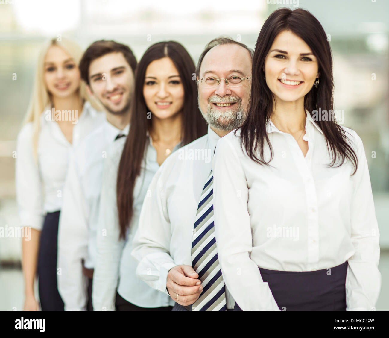 concept of team work - the leader and the business team standing one ...