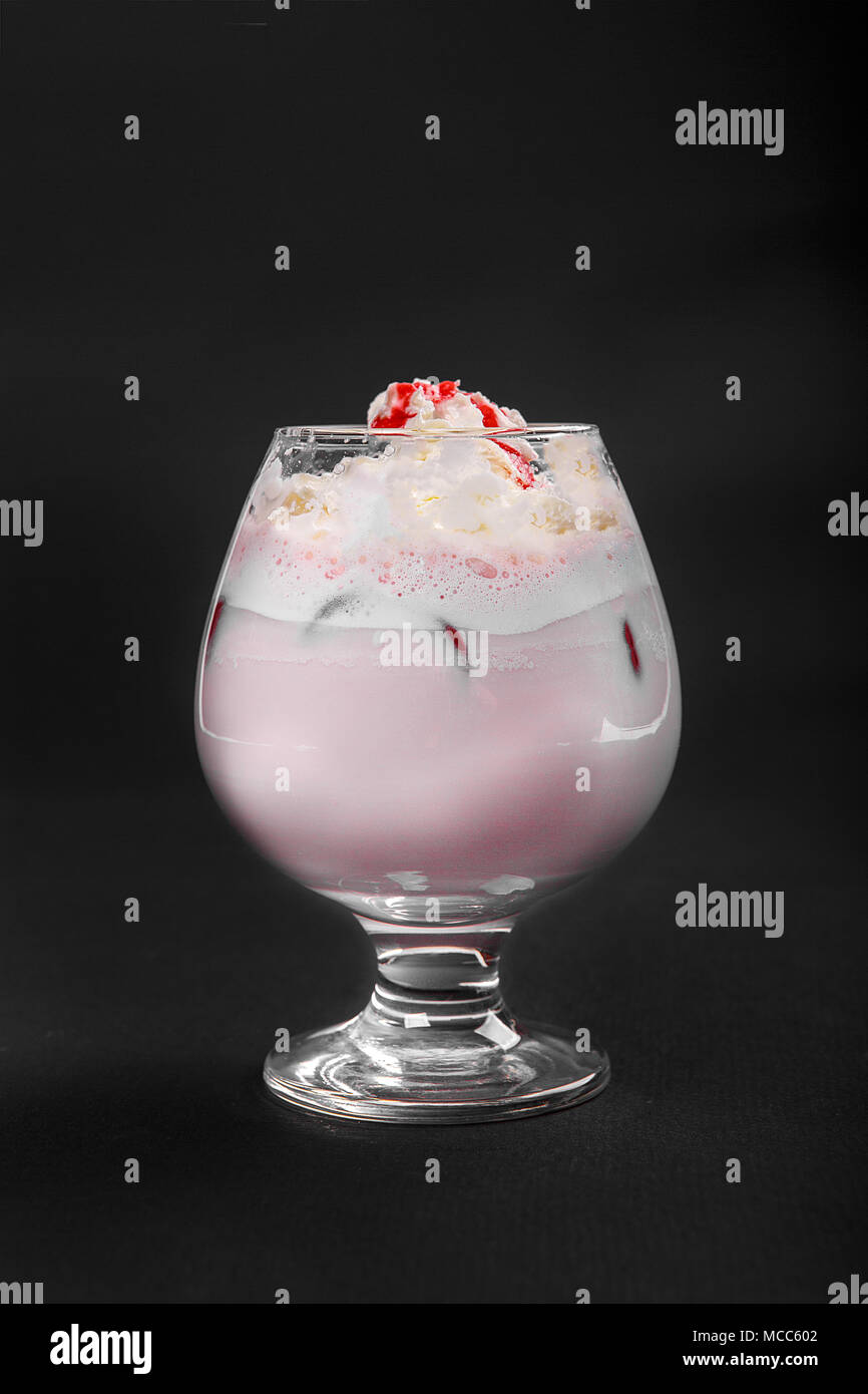 Pina colada, pink creamy cocktail in a low glass with crushed ice ...