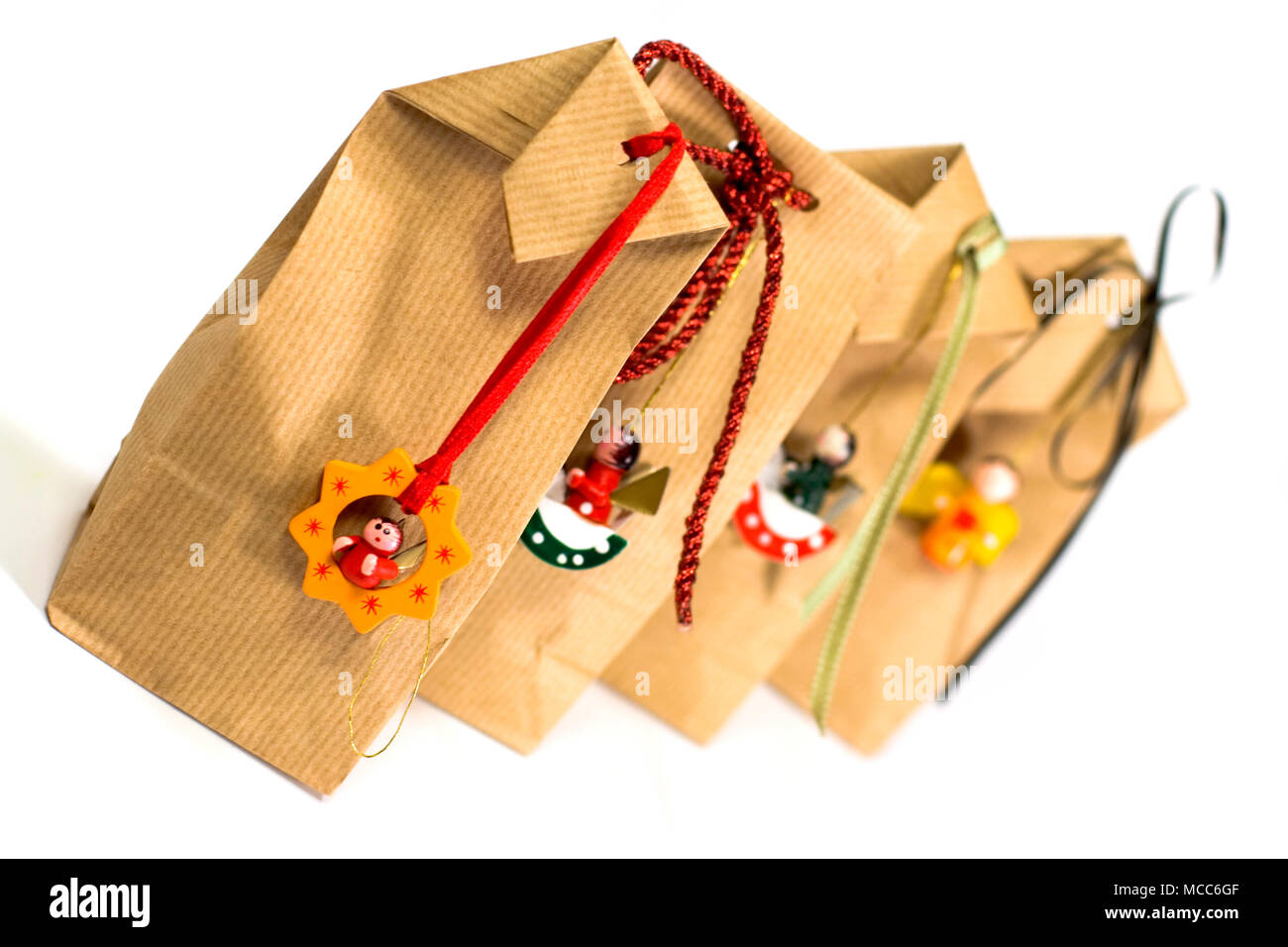 four brown gift bags with decorations isolated on white background ...