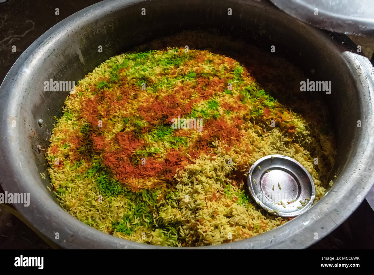 Multicolored rice is the background. Traditional Indian cuisine. Briany ...