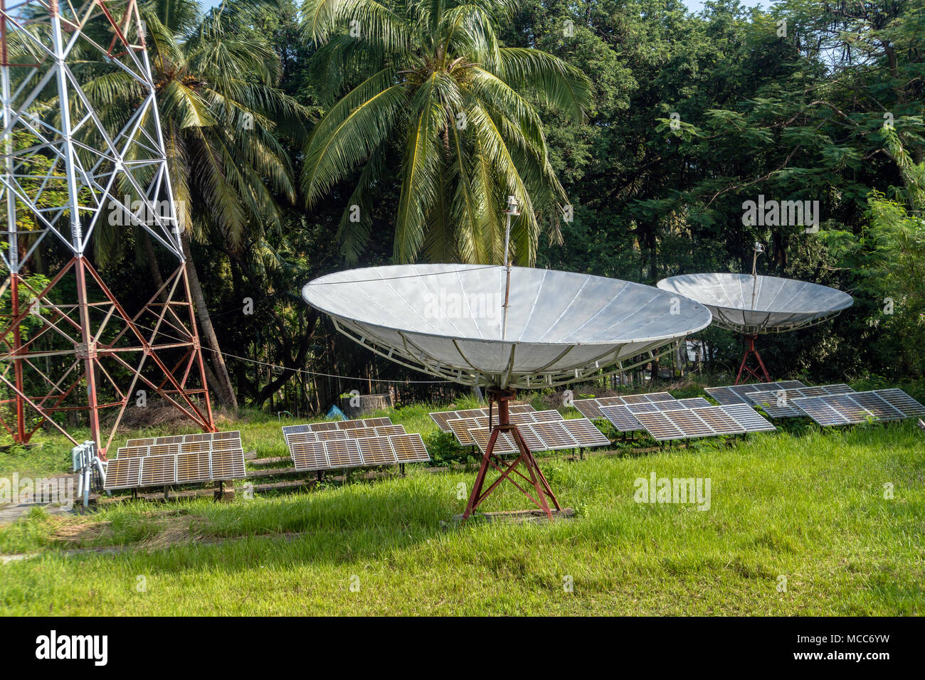 modern satellite dish and solar panels in the jungle forest. satellite ...