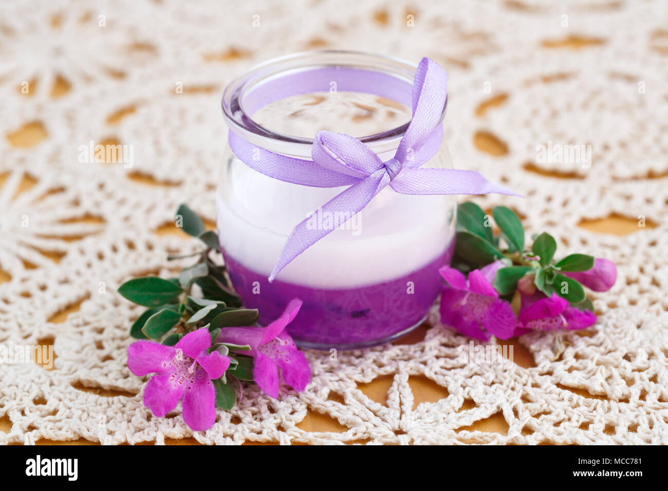 Beautiful candle and pink flowers on cloth background Stock Photo - Alamy