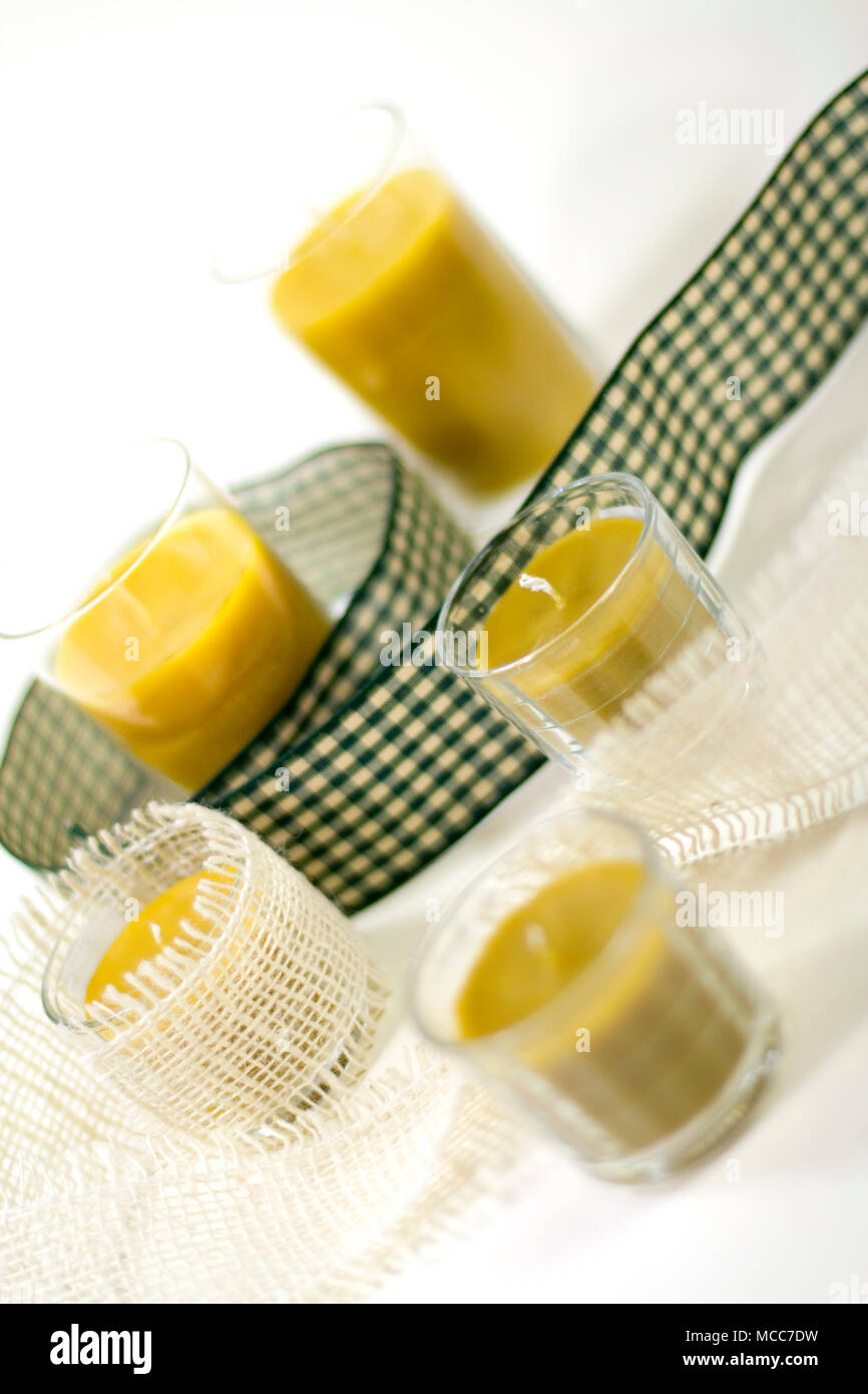 five yellow candles and green ribbon Stock Photo - Alamy