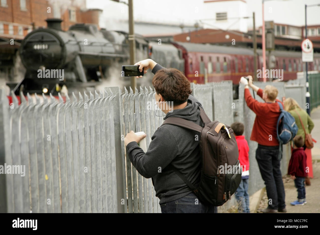 People taking photograph of steam hauled charter train at York station ...