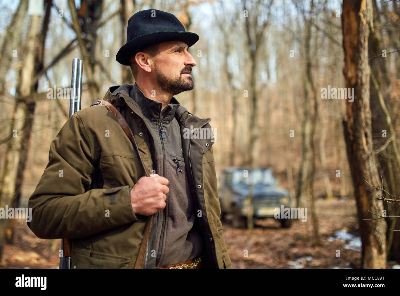 Game ranger with gun at the feeding spot for wild animals Stock Photo ...