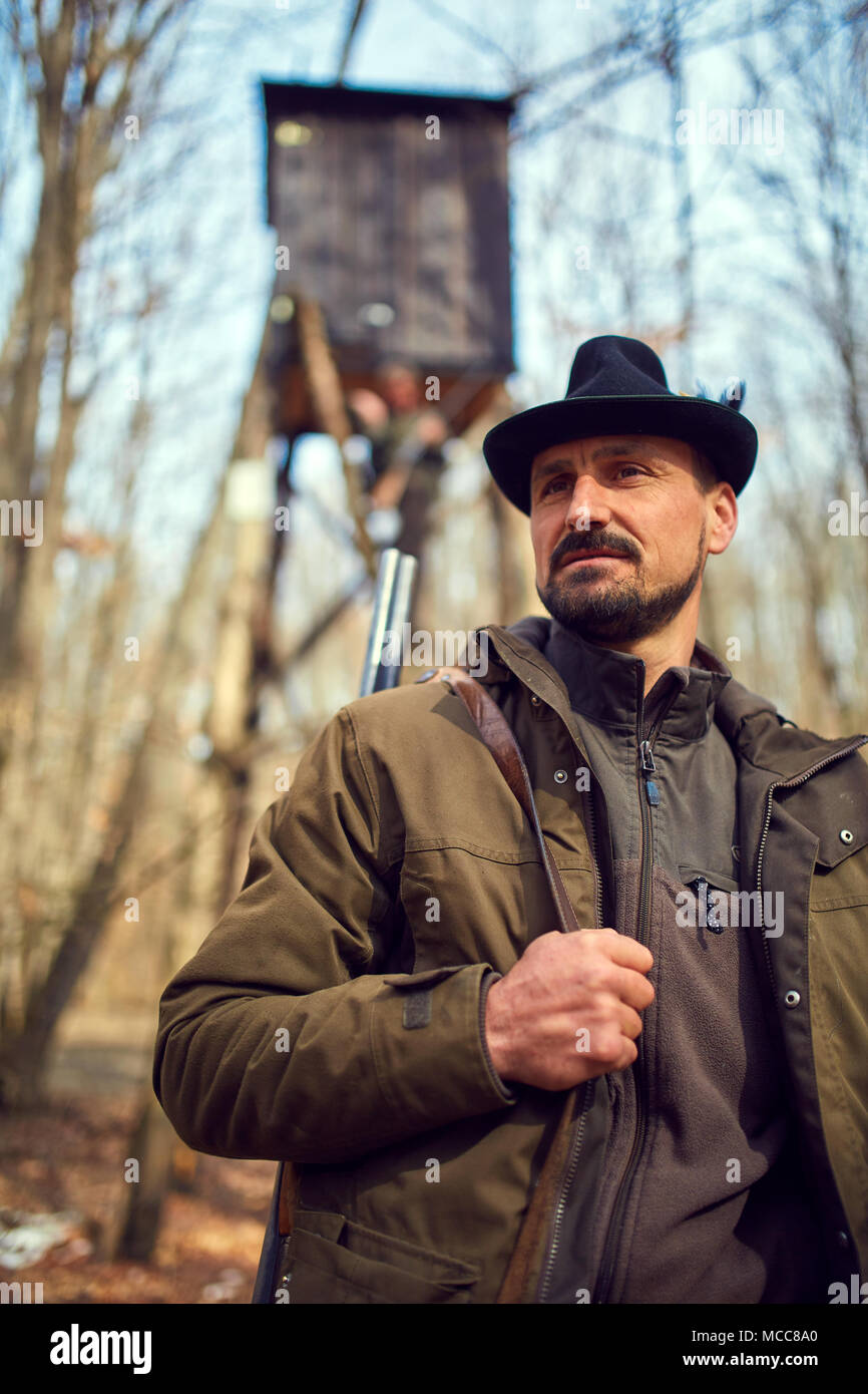 Game ranger with gun at the feeding spot for wild animals Stock Photo ...