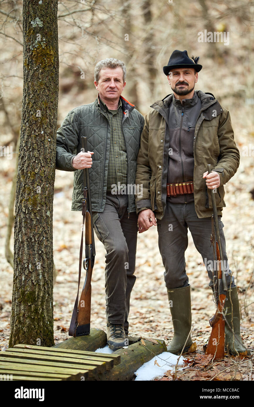 Game ranger with gun at the feeding spot for wild animals Stock Photo ...