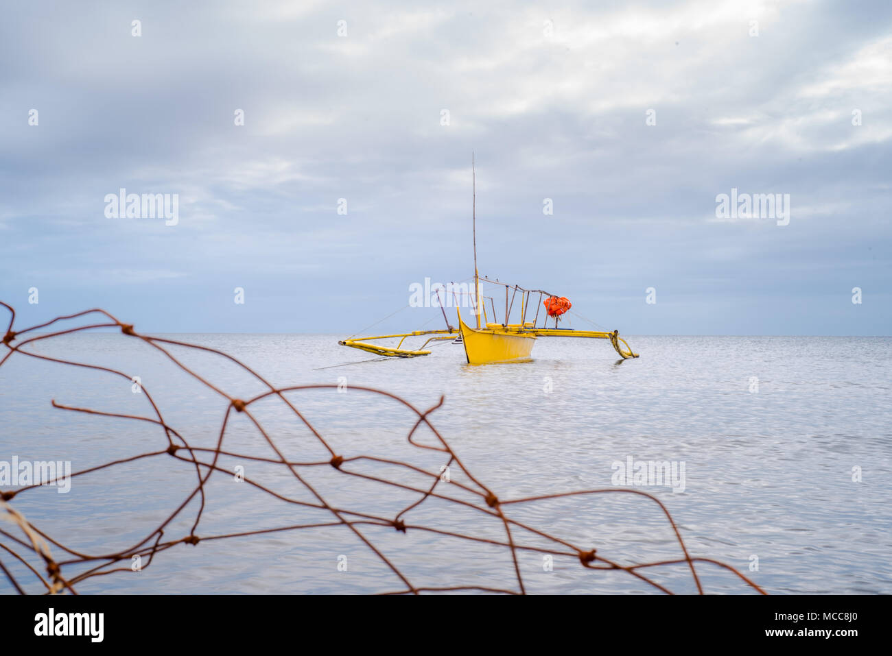 Yellow boat anchored at the shore Stock Photo - Alamy