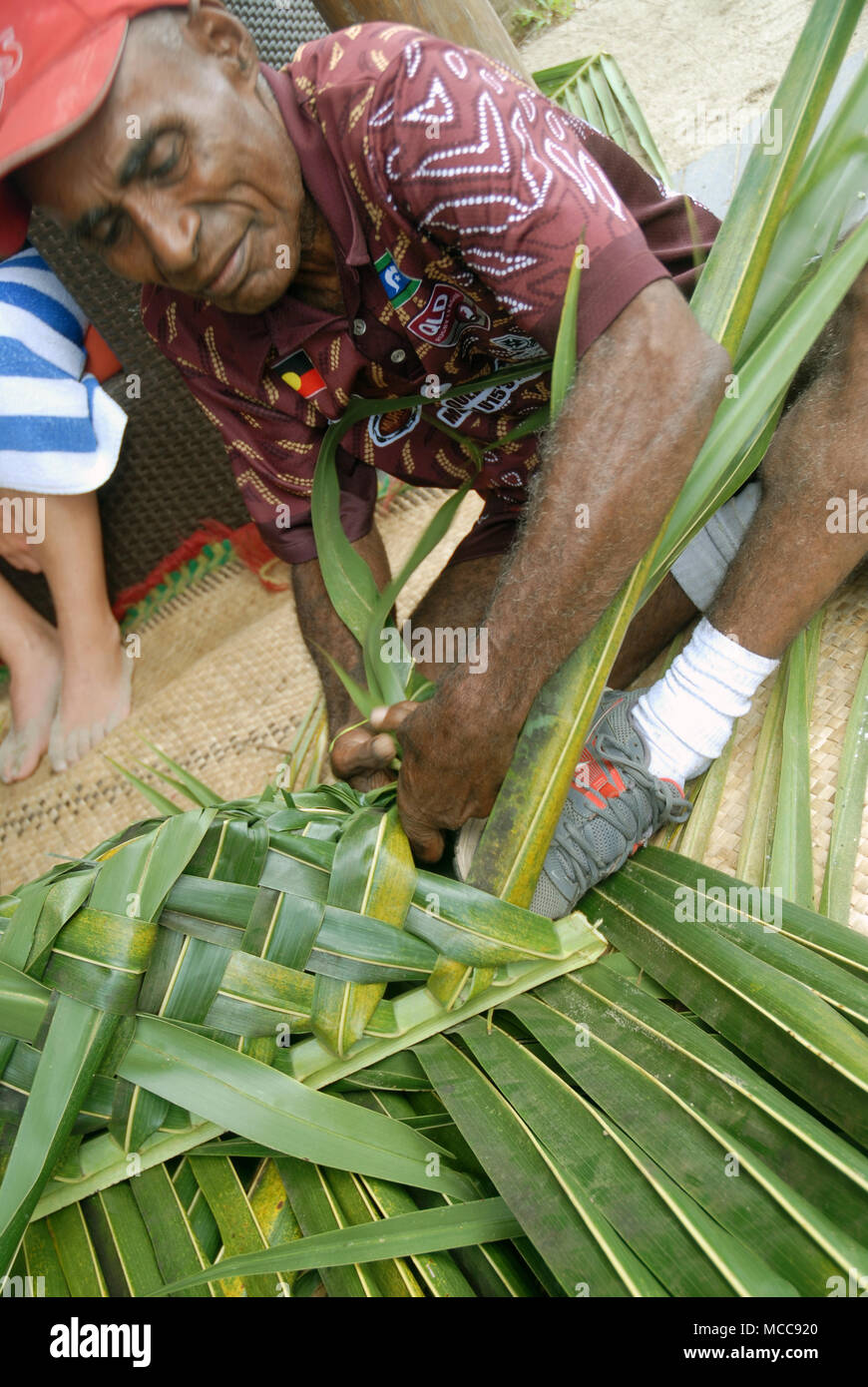 Fijian man creates a basket from weaving a Coconut Palm leaves, Pacific ...
