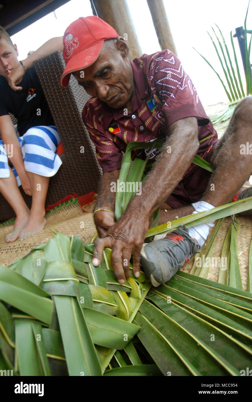Fijian man creates a basket from weaving a Coconut Palm leaves, Pacific ...
