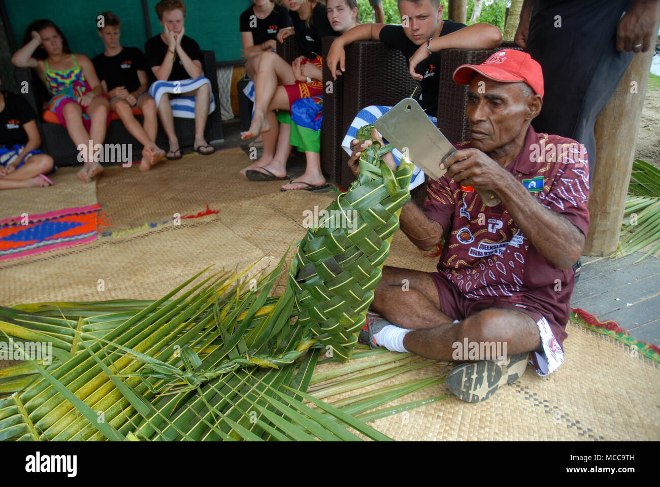 Fijian man creates a basket from weaving a Coconut Palm leaves, Pacific ...