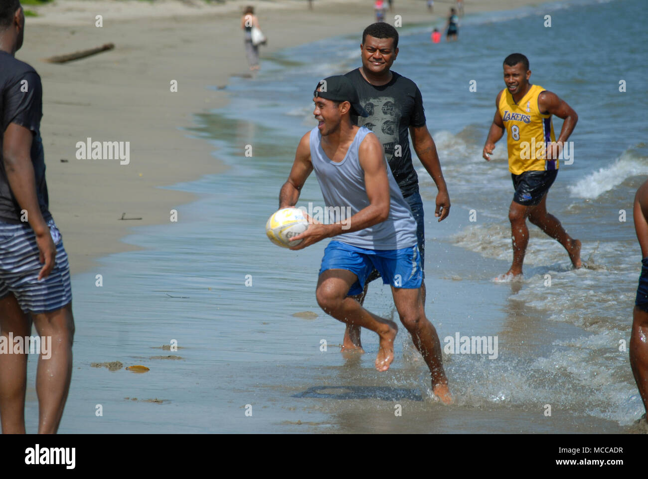 Fijian men playing rugby on beach hi-res stock photography and images ...