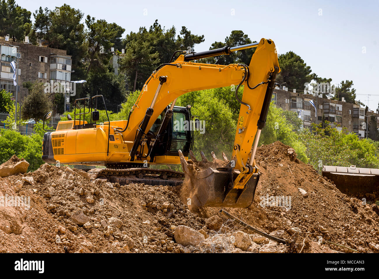 excavator loader machine with risen boom construction site yellow ...