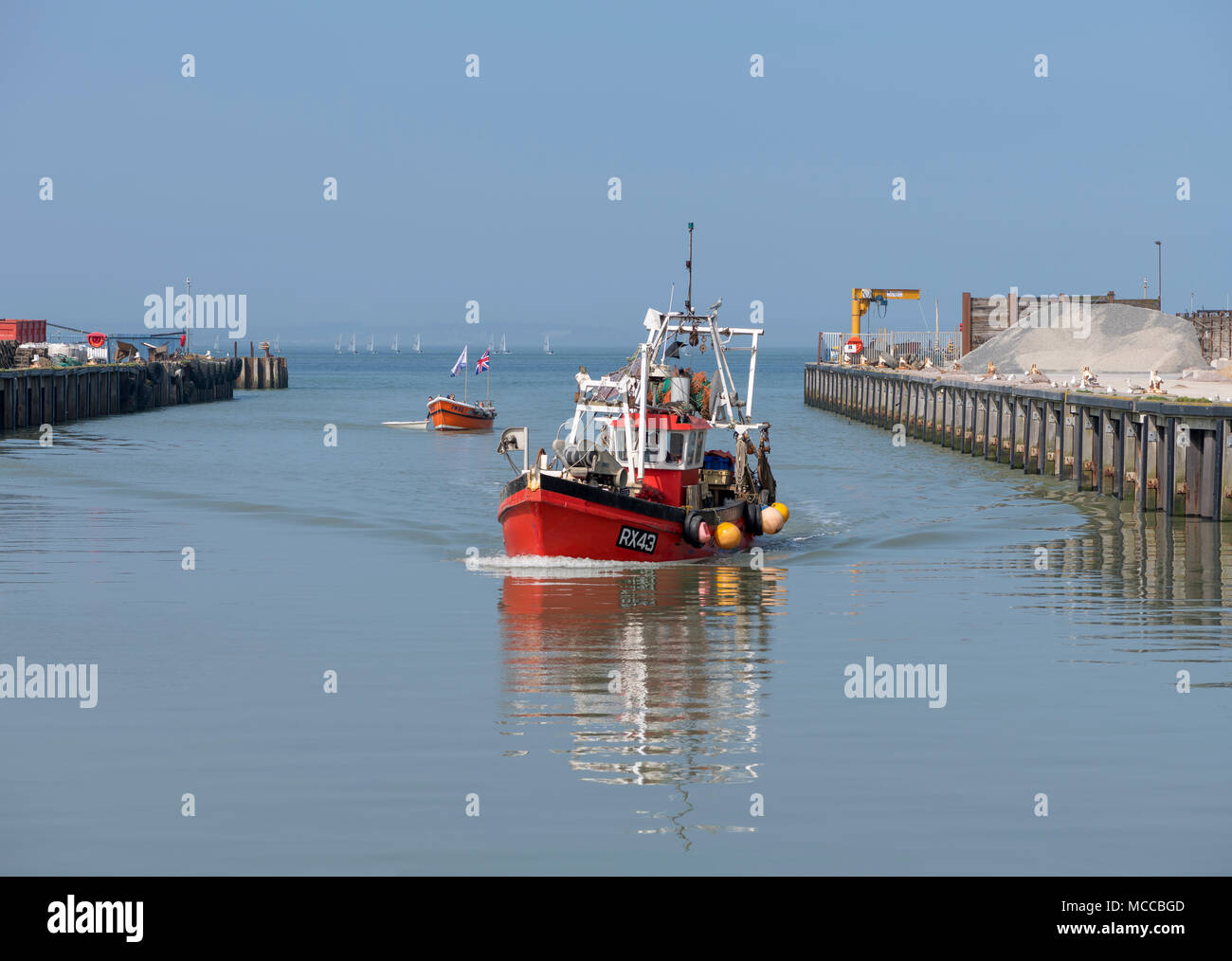 Small fishing boat entering Whitstable harbour Stock Photo - Alamy