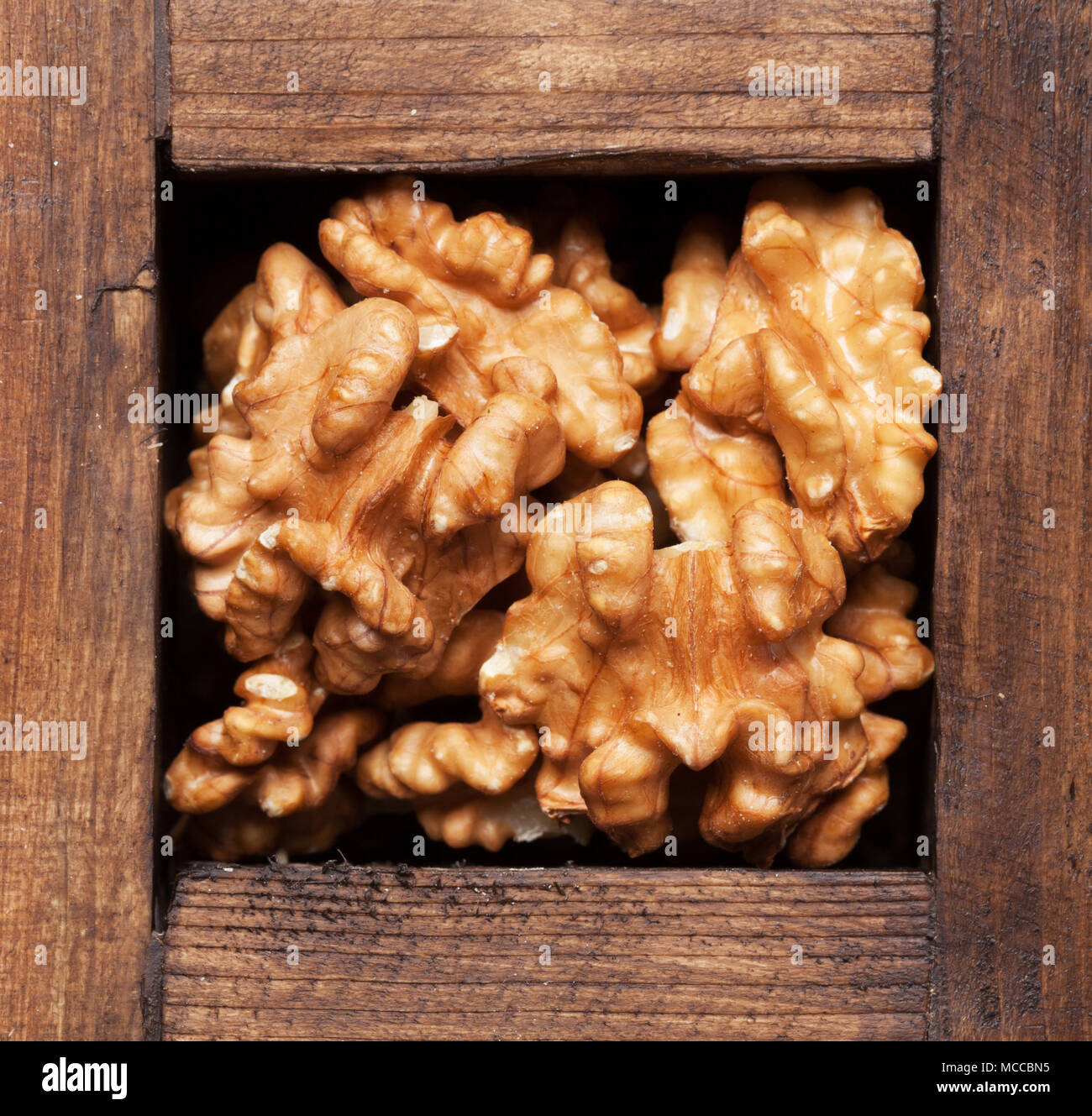 Walnut nuts in wooden box. Top view Stock Photo - Alamy