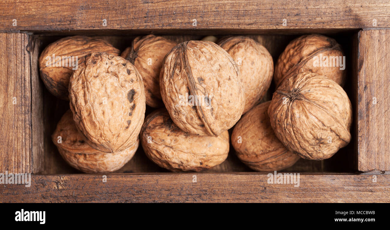 Walnut nuts in wooden box. Top view Stock Photo - Alamy