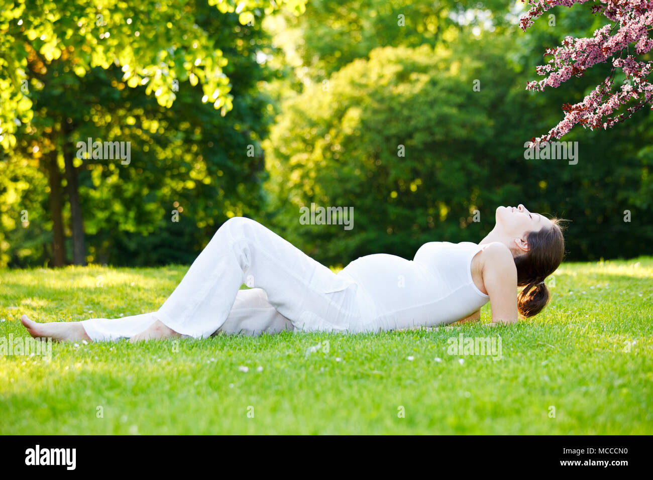Beautiful pregnant woman in the spring park Stock Photo - Alamy