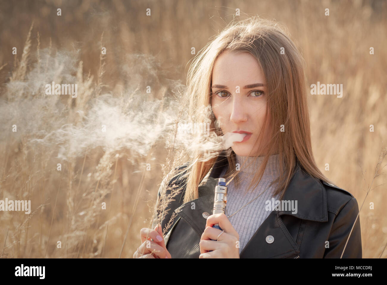 Smoking girl in leather hi-res stock photography and images - Alamy