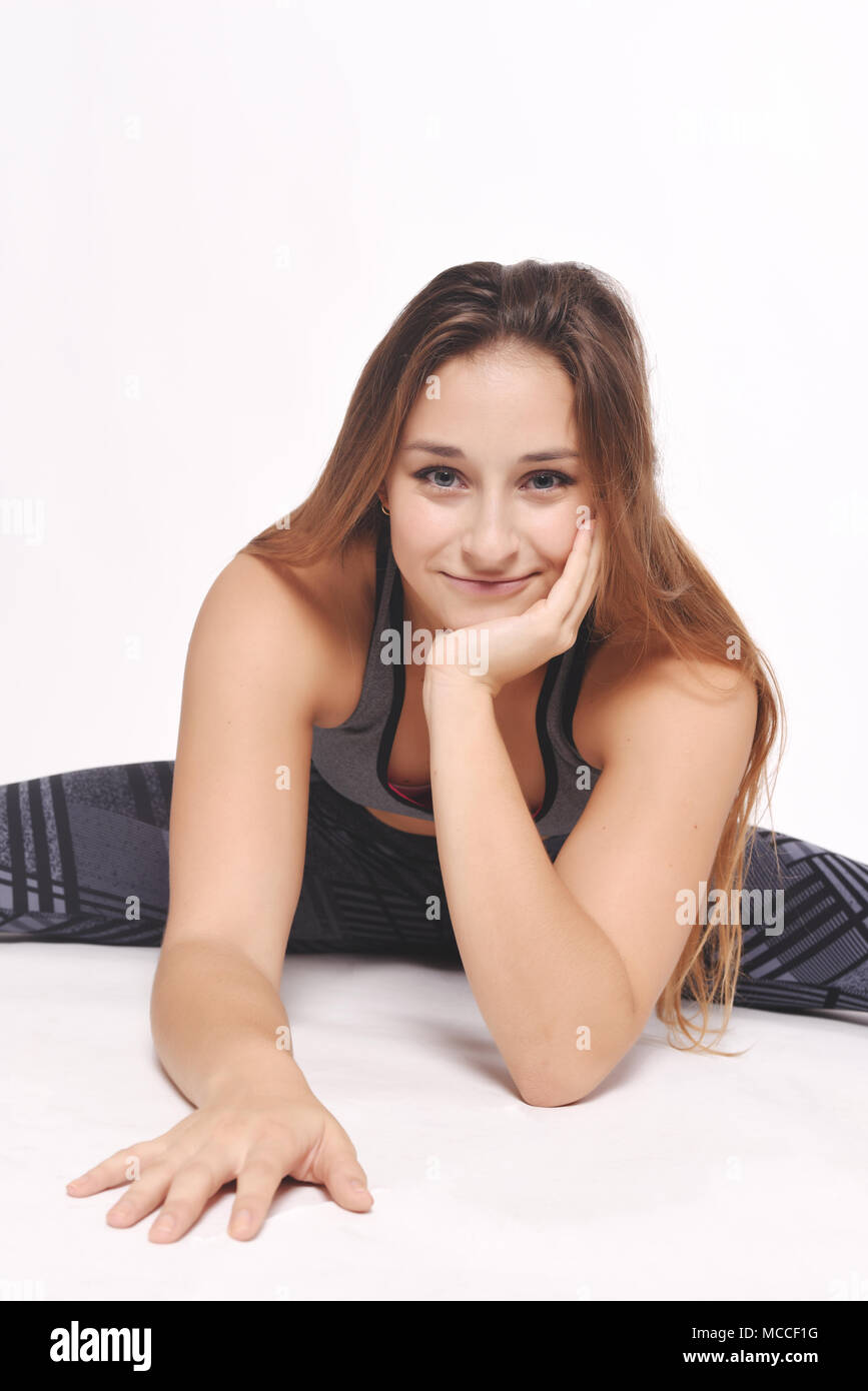 Portrait of athlete young woman doing exercise. Isolated white ...