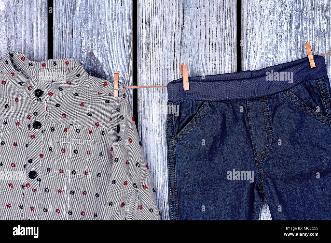 Boys clothes drying on rope. Little boy jeans and t-shirt hanging on ...