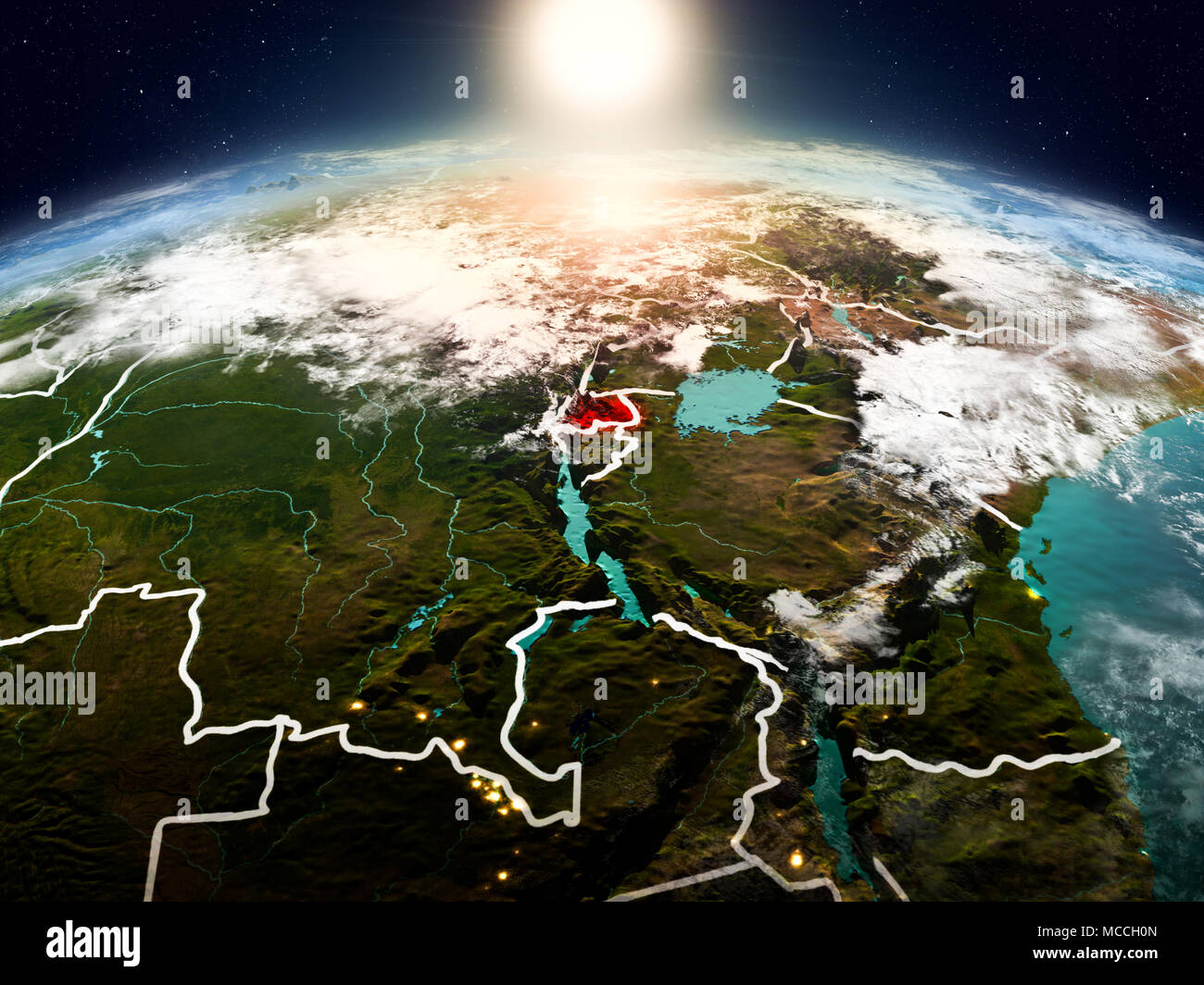 Sunrise above Rwanda highlighted in red on model of planet Earth in space with visible country ...