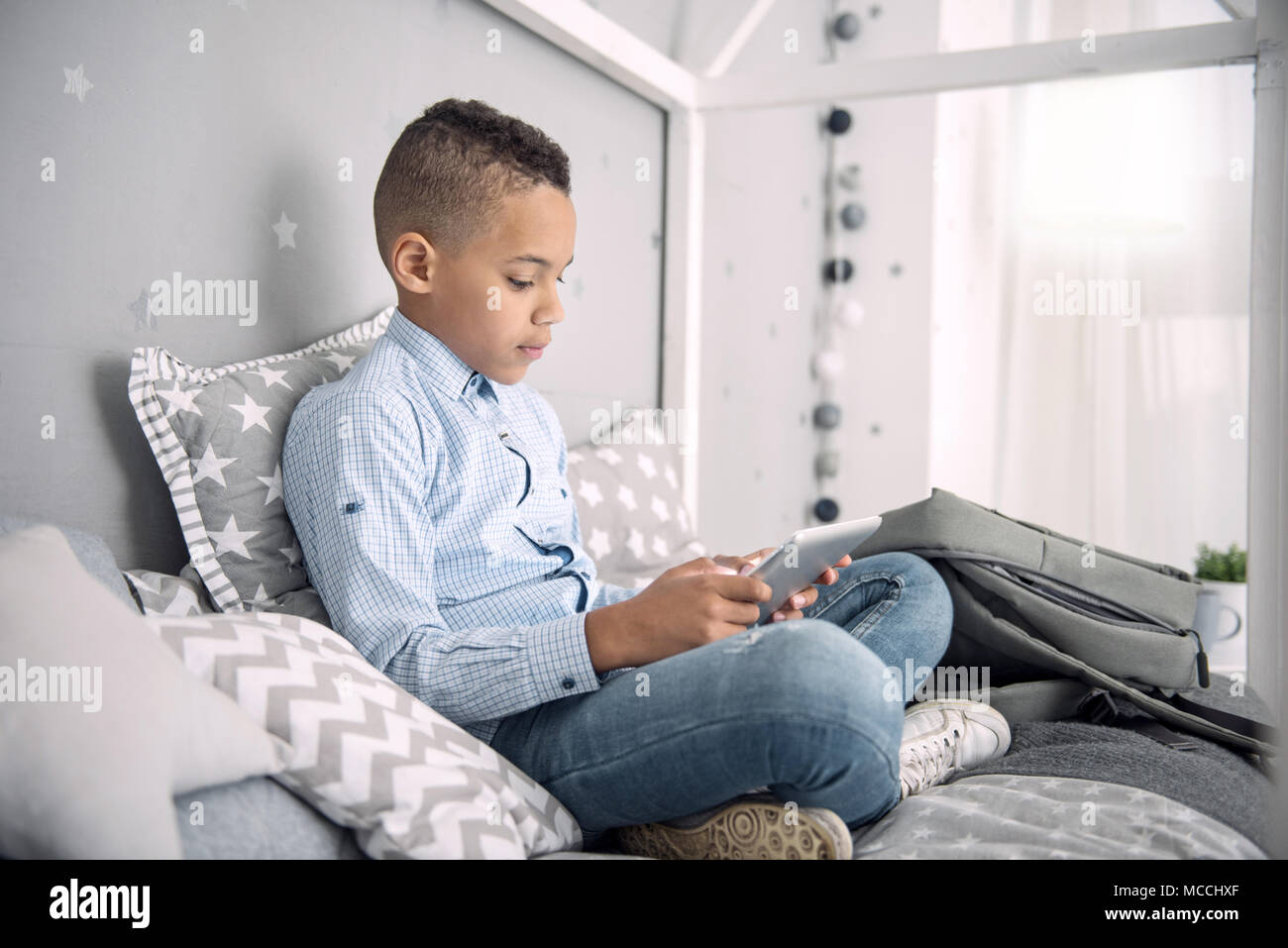 Pensive pleasant boy discovering new information Stock Photo - Alamy