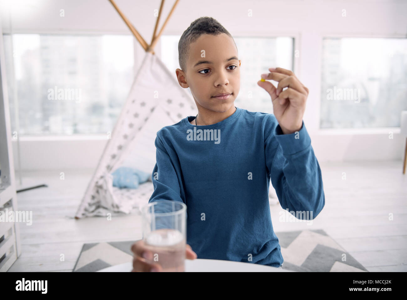 Pleasant nice boy taking drugs Stock Photo - Alamy