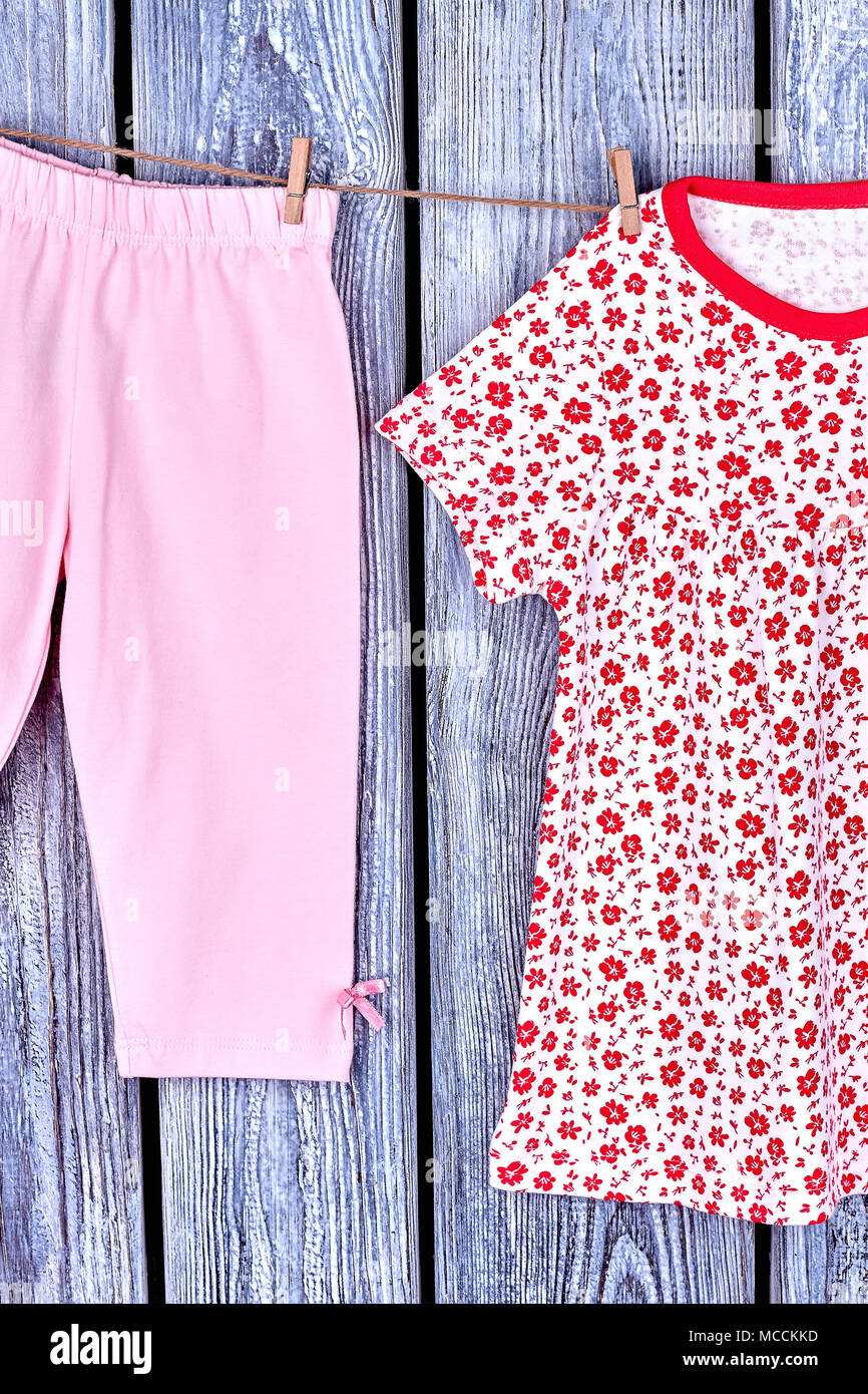 Little girl clothes on clothesline. Infant girl pants and patterned ...