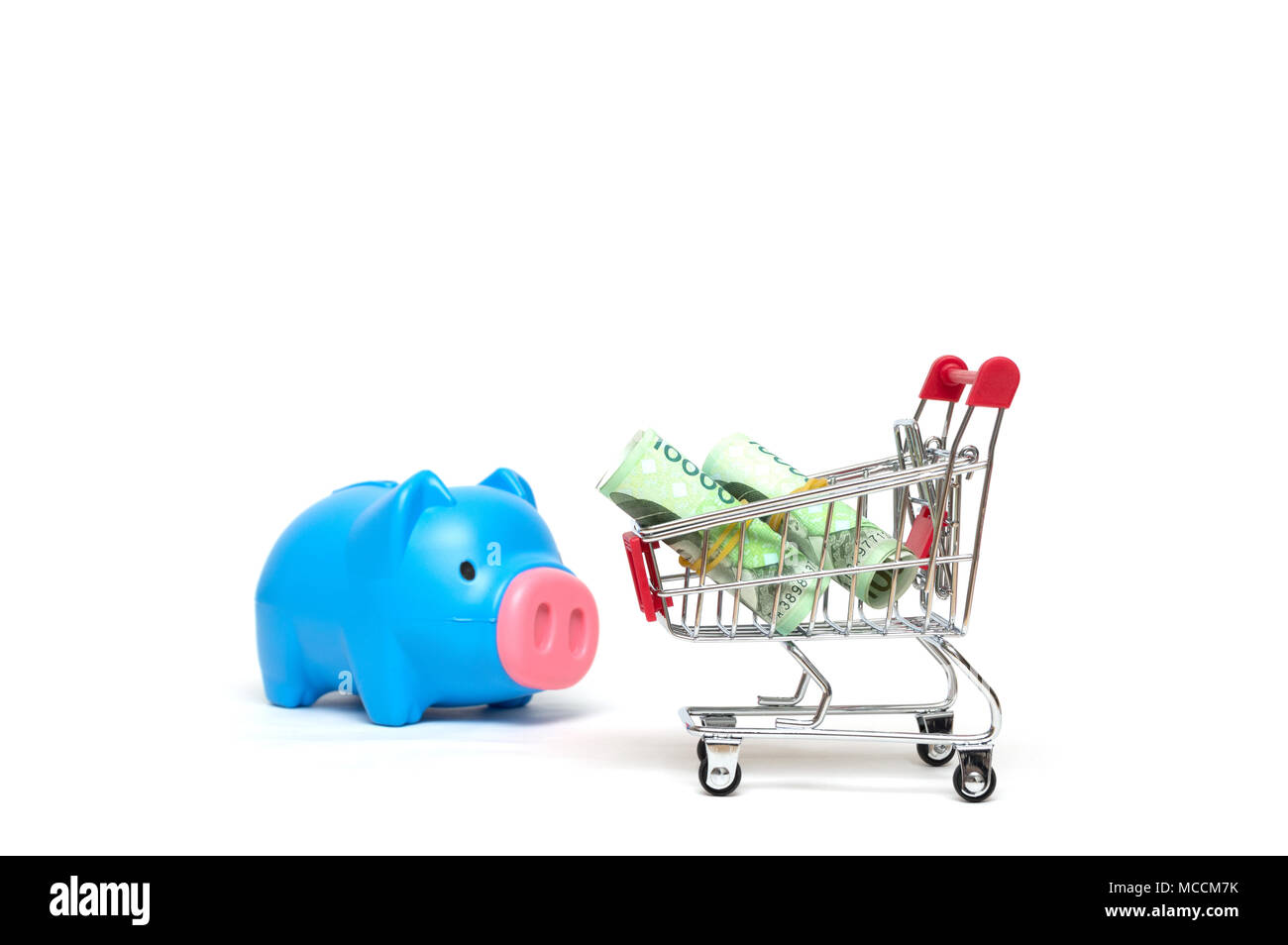 Piggy bank and korean money and shopping cart on white background ...