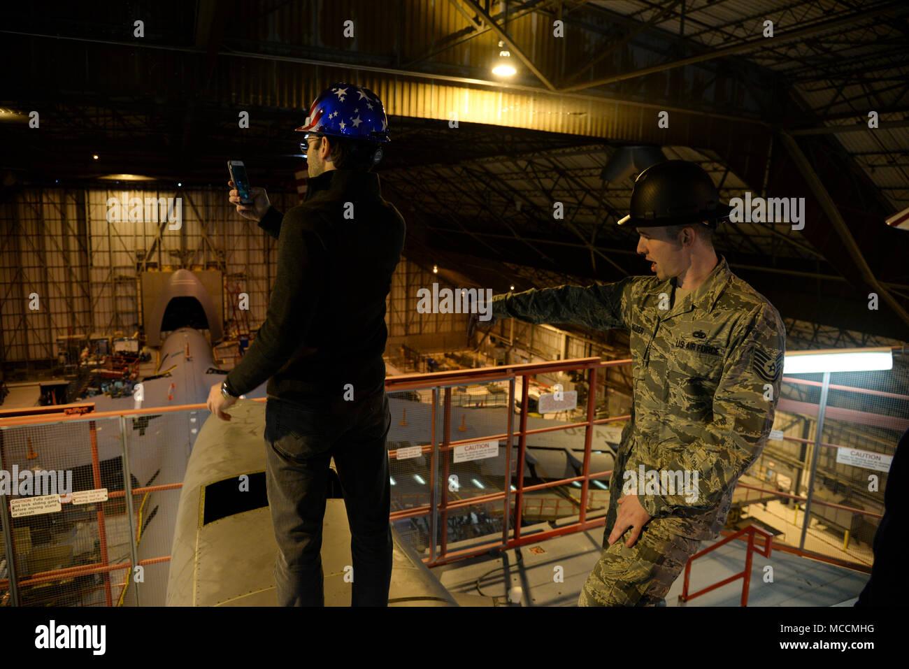 Simon Sinek takes a photo of a C-5M Super Galaxy atop the plane’s tail ...