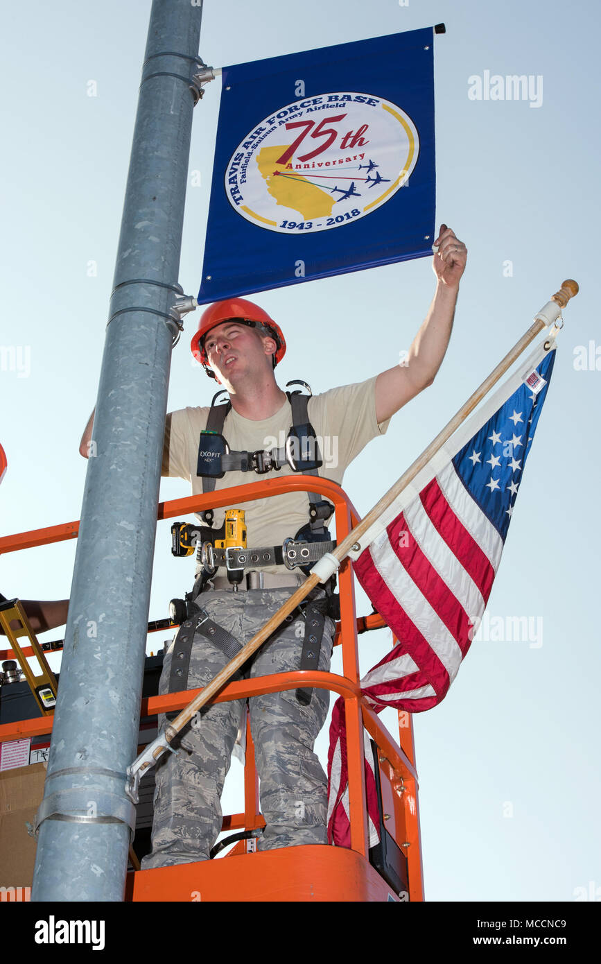 An Airman from the 60th Civil Engineer Squadron attaches the 75th ...