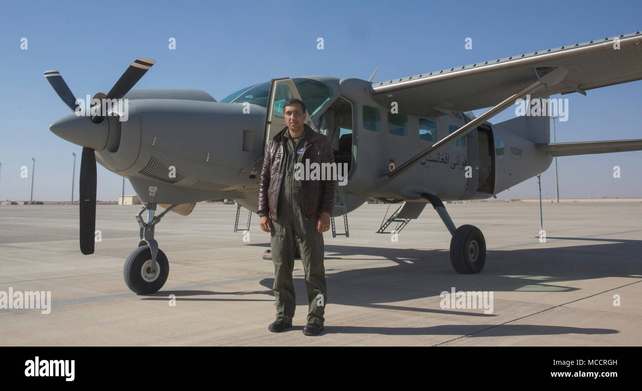 A pilot with the Afghanistan Air Force (AAF) stands in front of his ...
